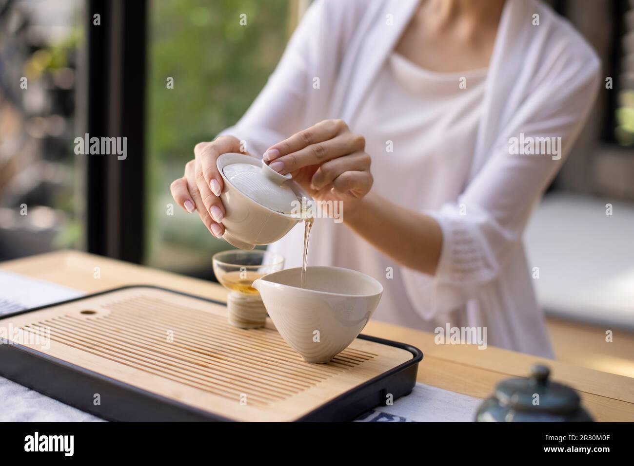 Elegant young Chinese woman drinking tea in tea room Stock Photo - Alamy