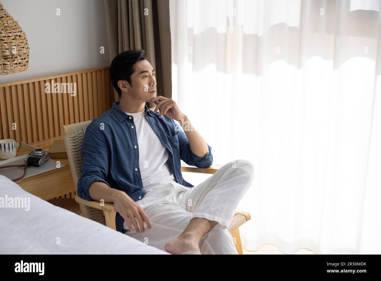 Mid adult Chinese man relaxing at home Stock Photo - Alamy