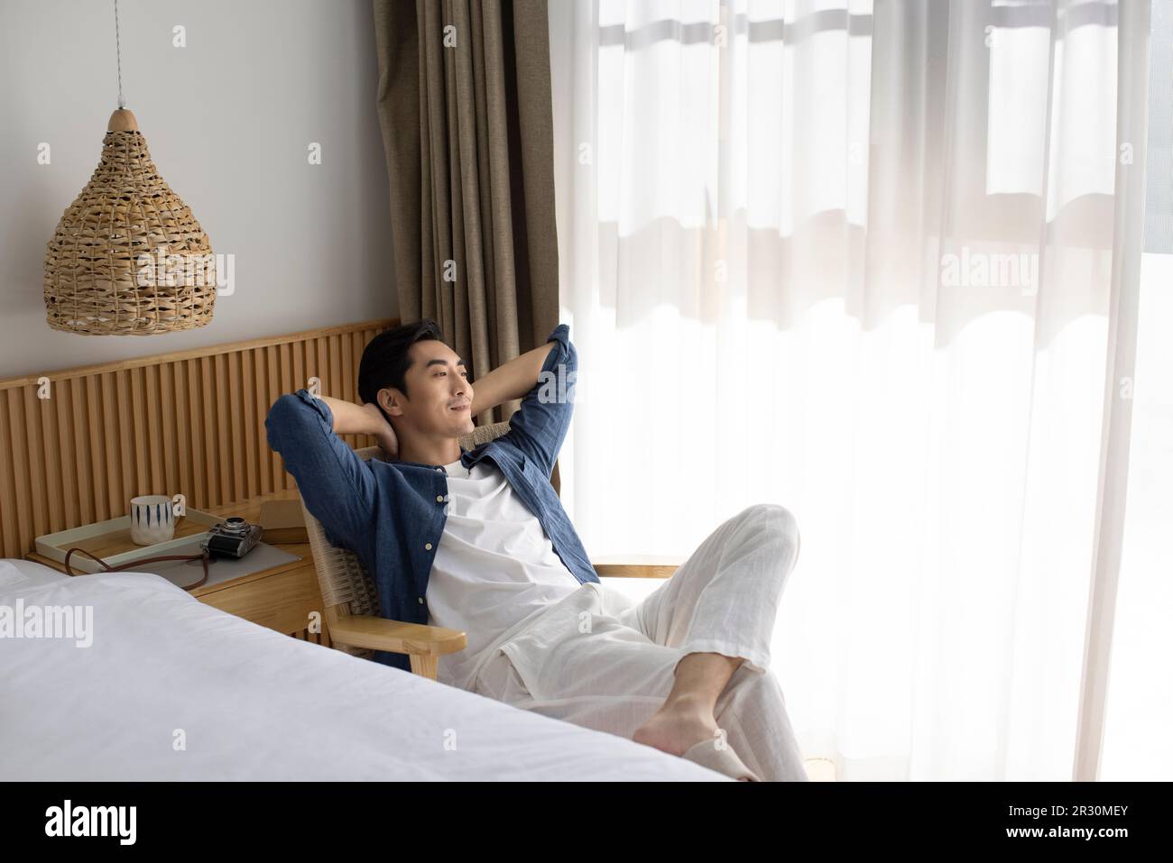 Mid adult Chinese man relaxing at home Stock Photo - Alamy