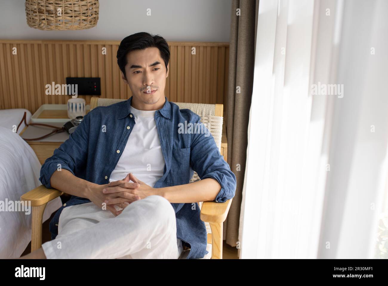 Mid adult Chinese man relaxing at home Stock Photo - Alamy