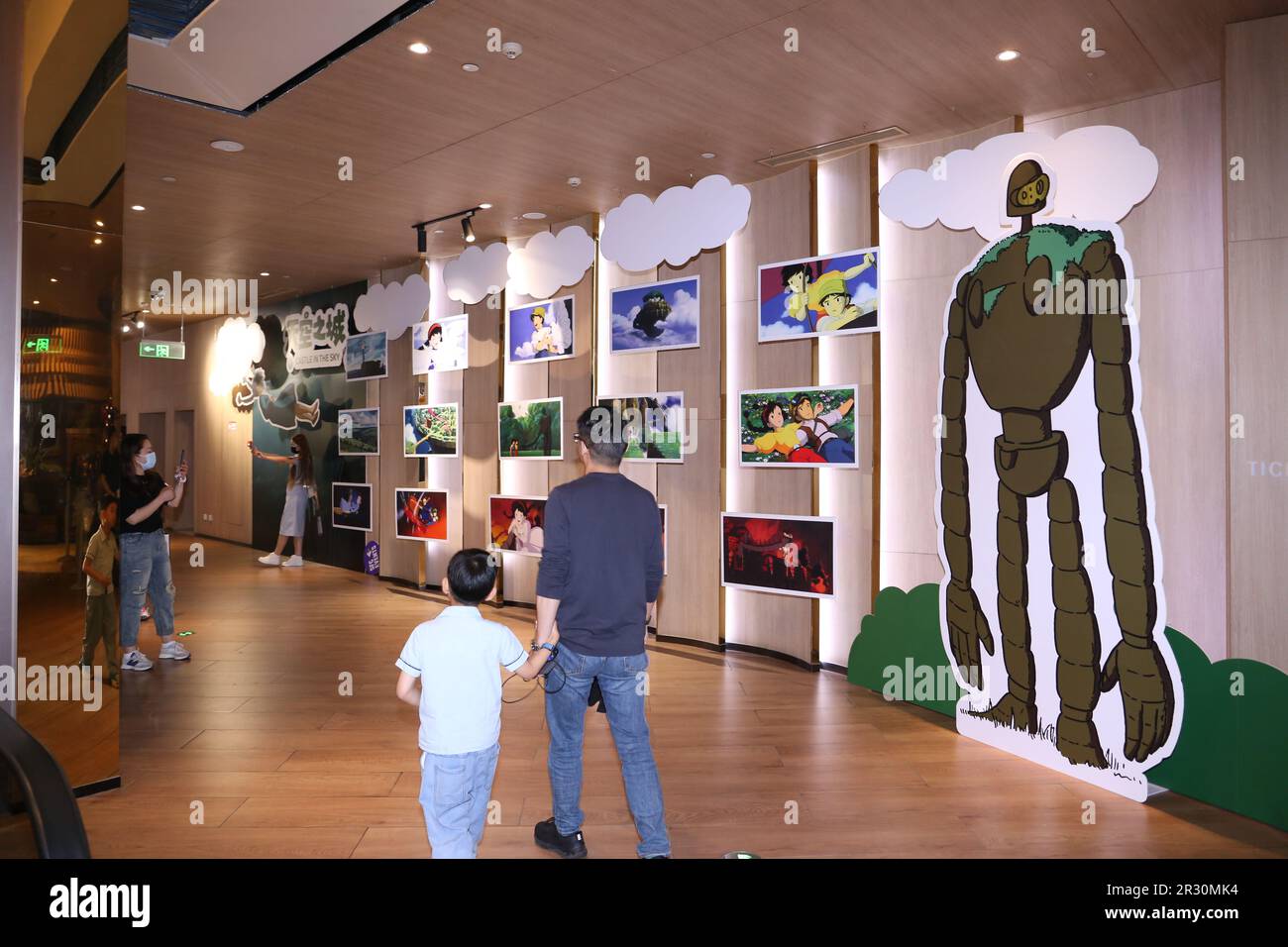 SHANGHAI, CHINA - MAY 21, 2023 - Citizens pass a poster of the classic ...