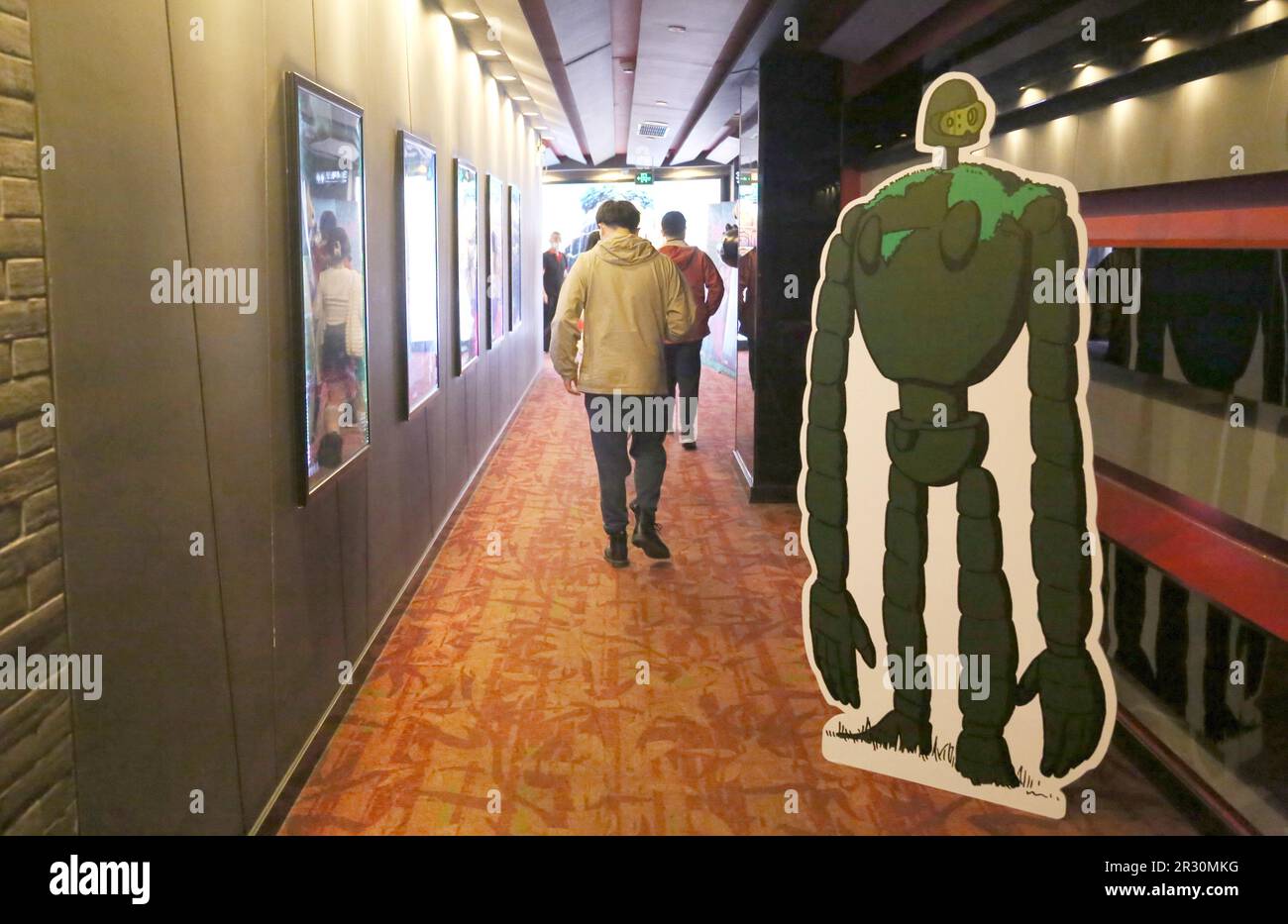 SHANGHAI, CHINA - MAY 21, 2023 - Citizens pass a poster of the classic ...