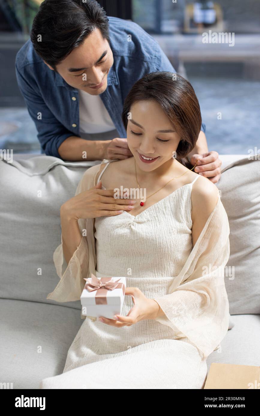 Happy young Chinese woman receiving gift from her husband Stock Photo ...