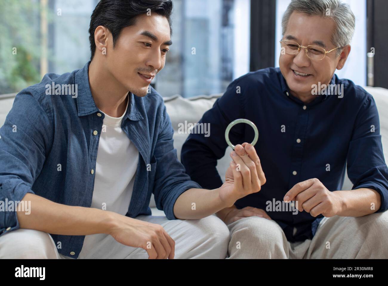 Smiling chinese father holding hi-res stock photography and images - Alamy