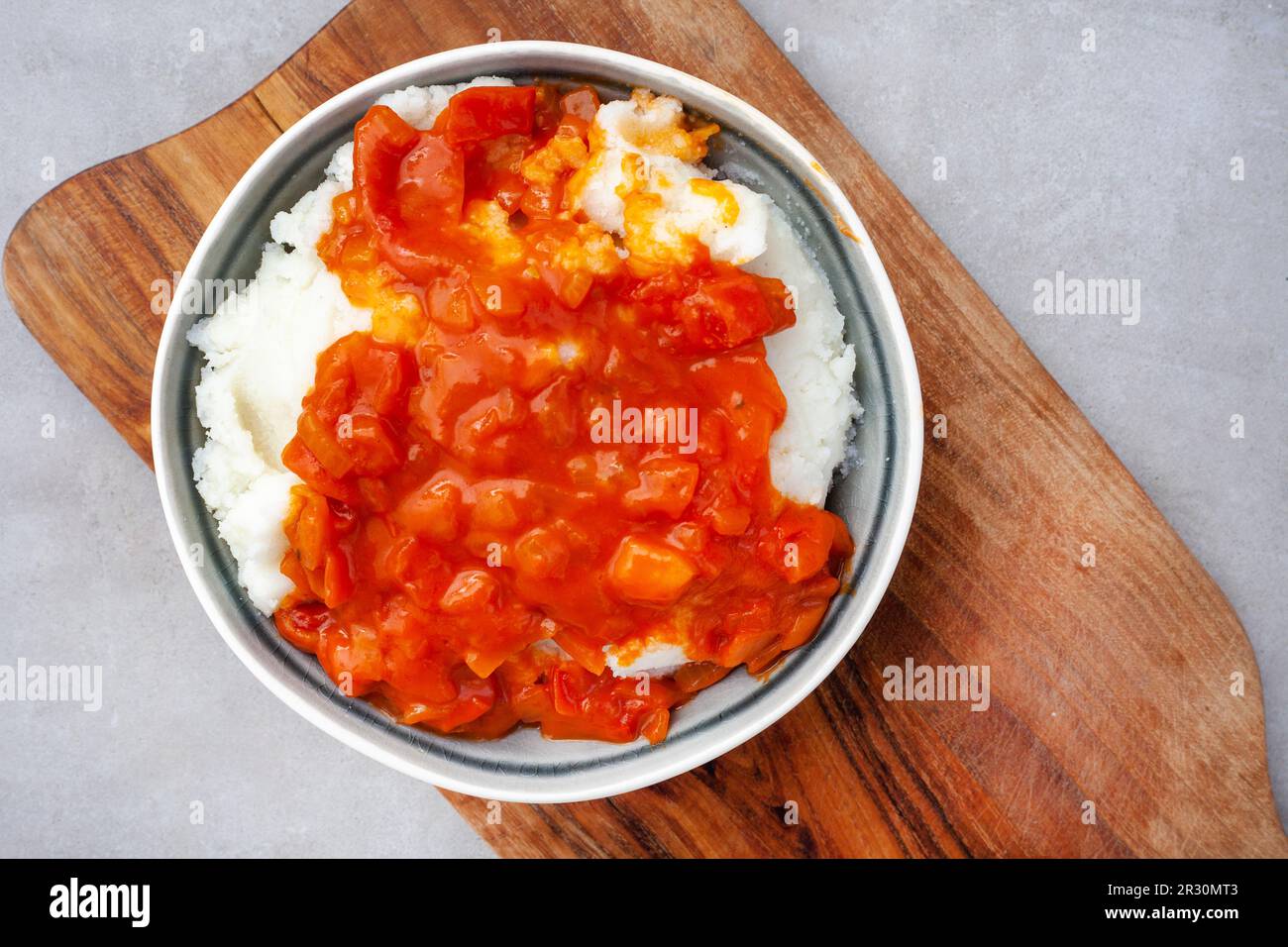 Traditional South African pap or maize meal with traditional sauce of ...