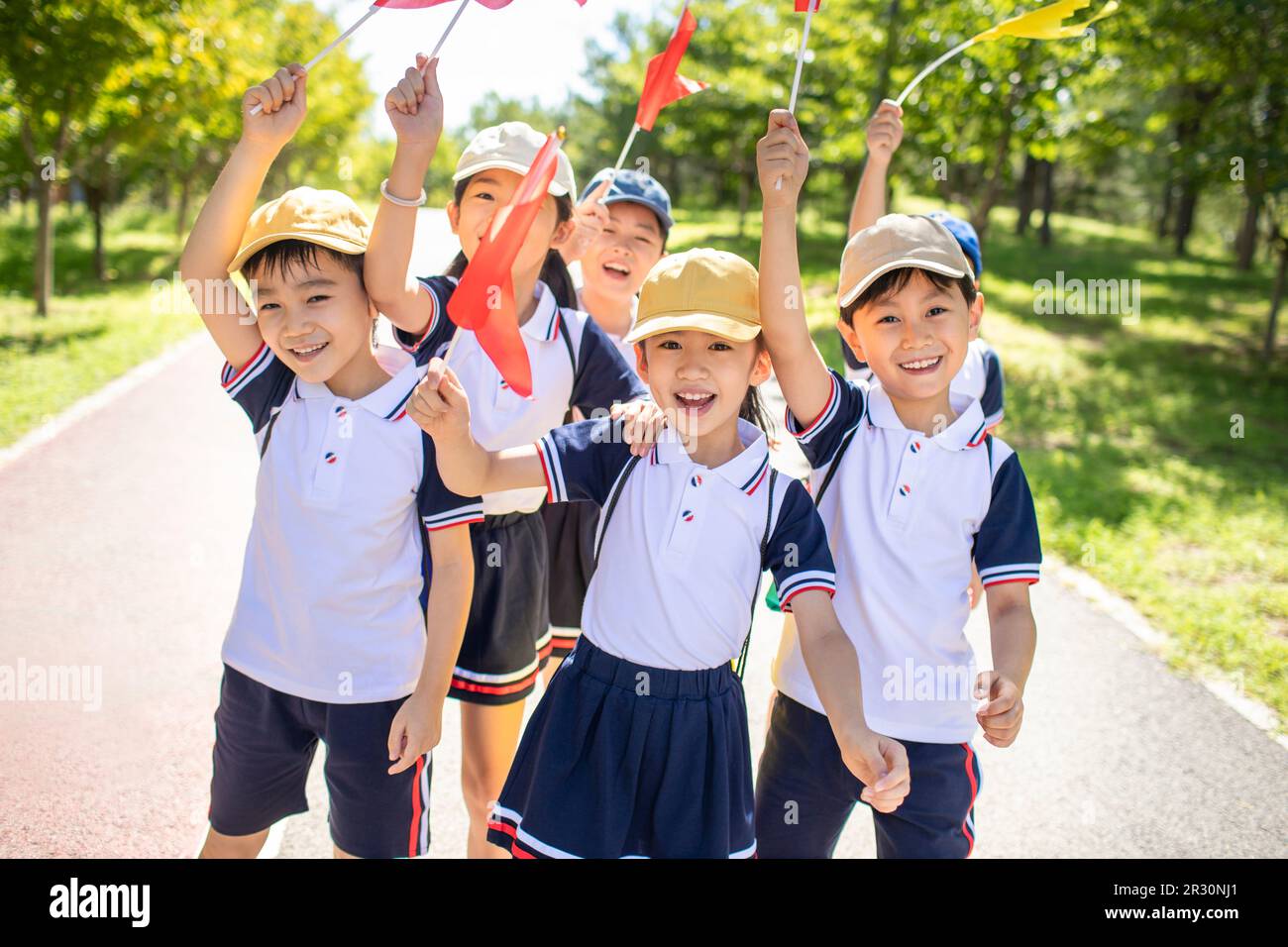 Cheerful Chinese school children relaxing in park Stock Photo - Alamy