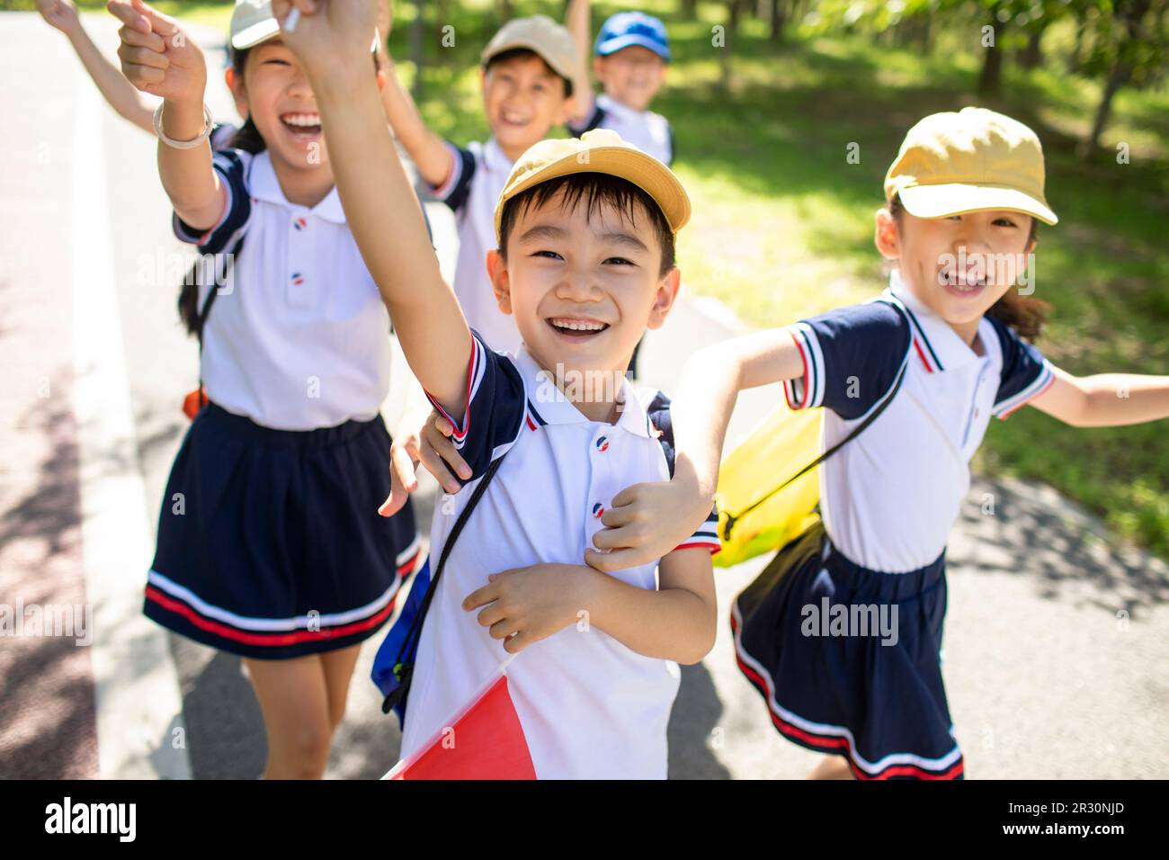 Cheerful Chinese school children relaxing in park Stock Photo - Alamy