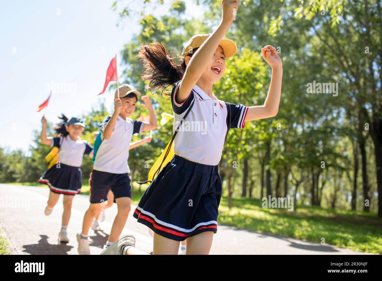 Cheerful Chinese school children relaxing in park Stock Photo - Alamy