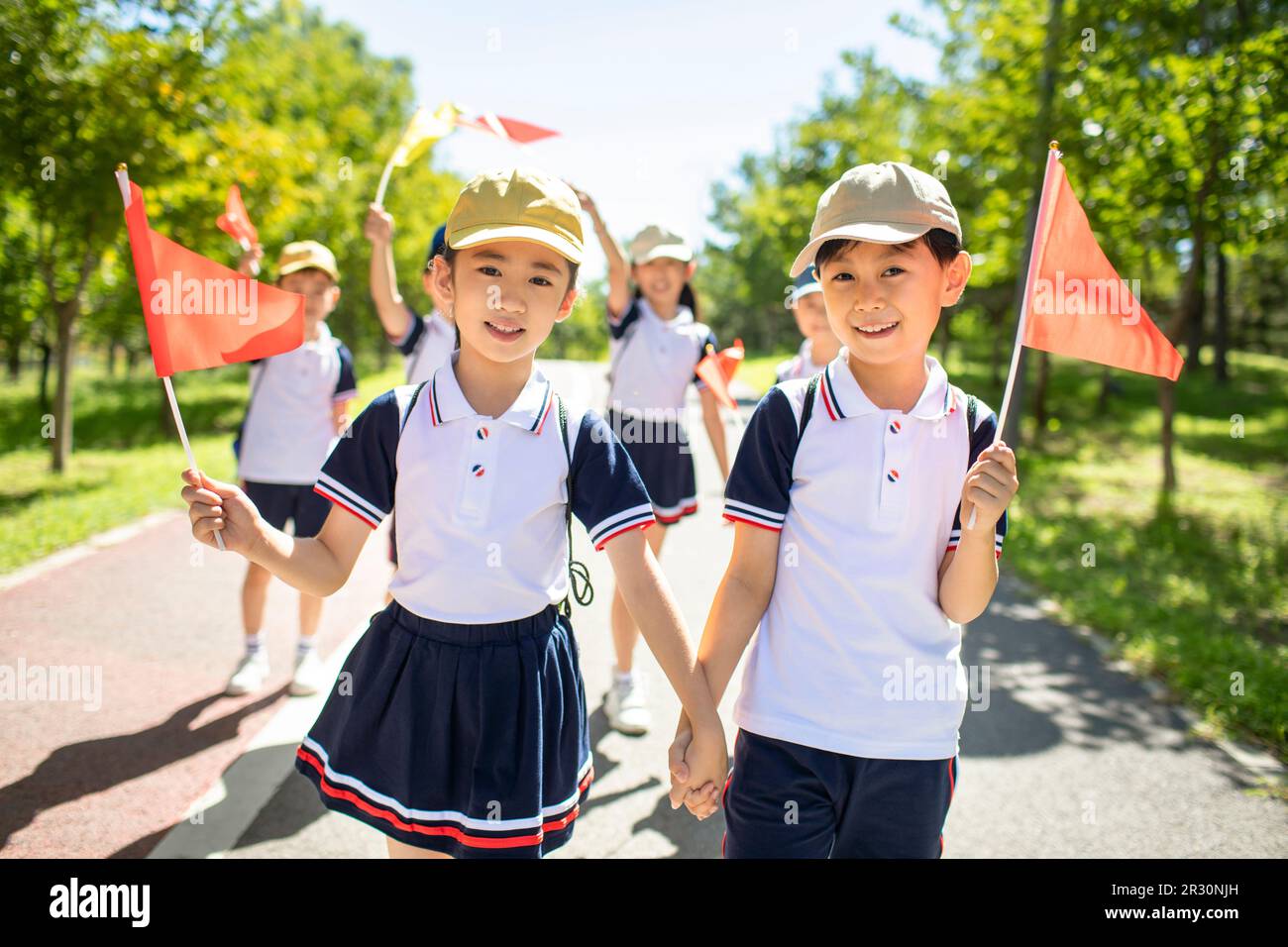 Cheerful Chinese school children relaxing in park Stock Photo - Alamy