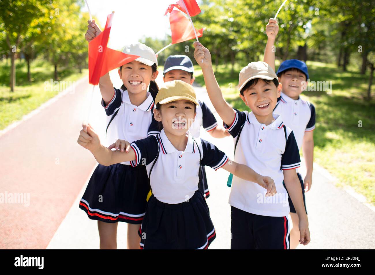 Cheerful Chinese school children relaxing in park Stock Photo - Alamy