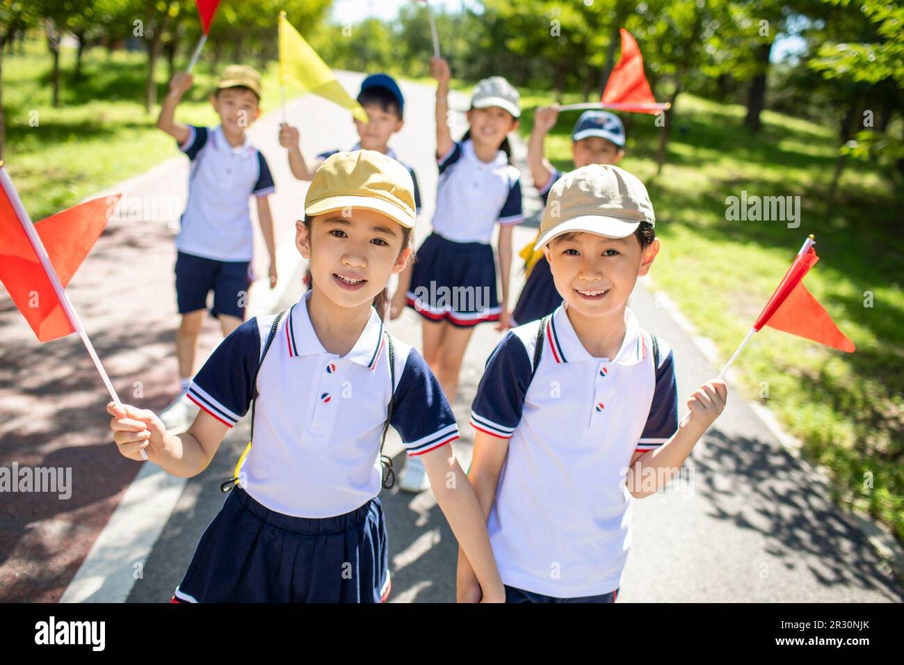 Cheerful Chinese school children relaxing in park Stock Photo - Alamy