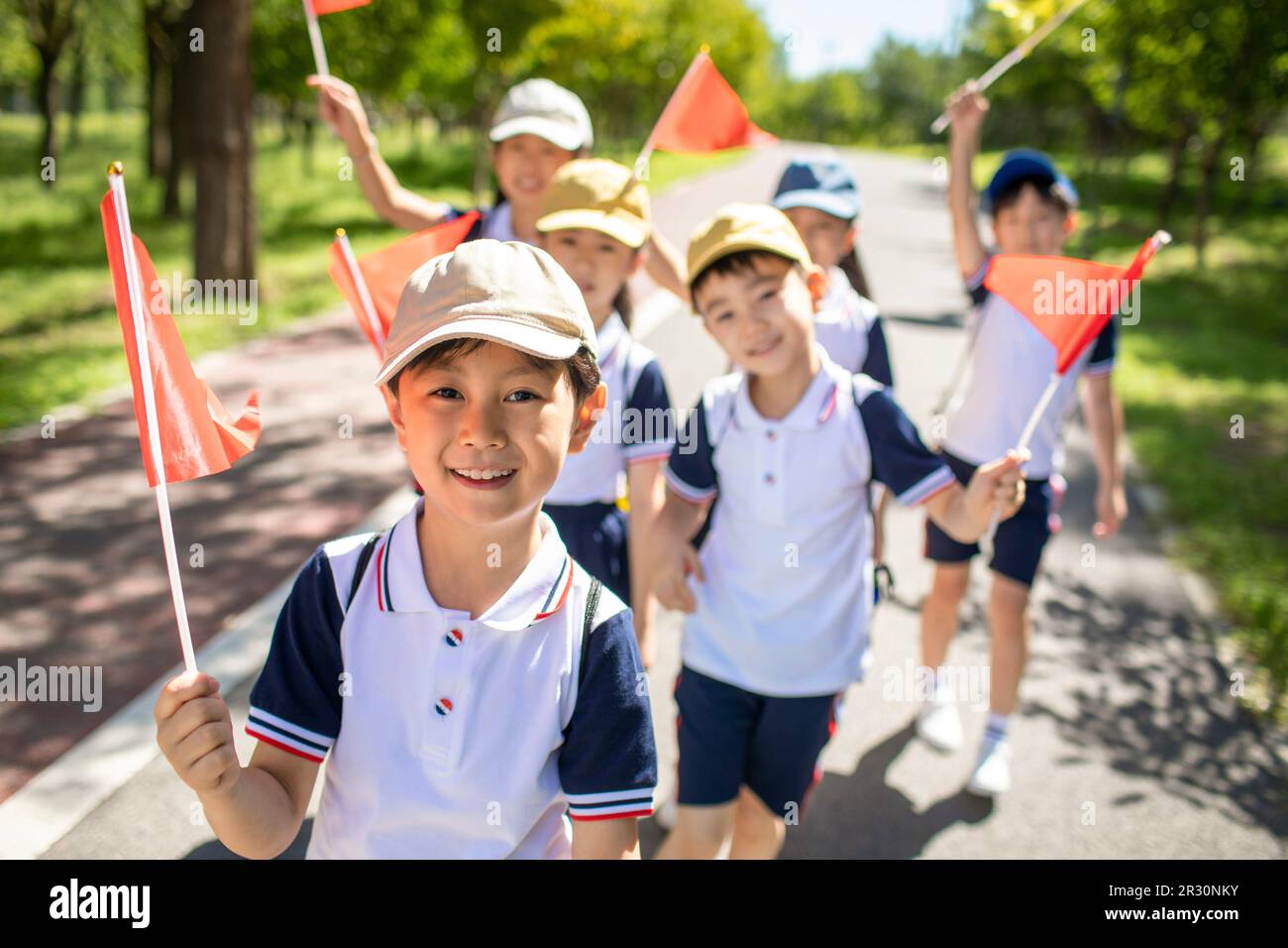 Cheerful Chinese school children relaxing in park Stock Photo - Alamy