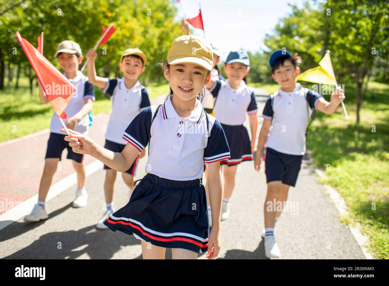 Cheerful Chinese school children relaxing in park Stock Photo - Alamy