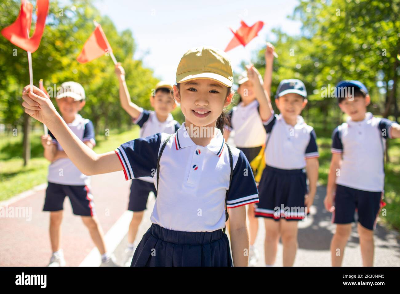 Cheerful Chinese school children relaxing in park Stock Photo - Alamy