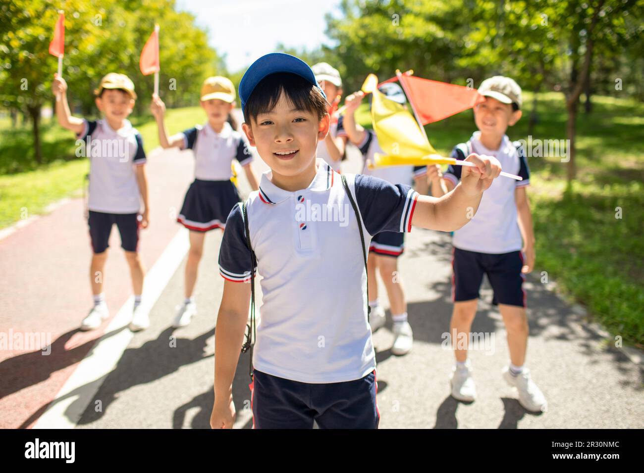 Cheerful Chinese school children relaxing in park Stock Photo - Alamy