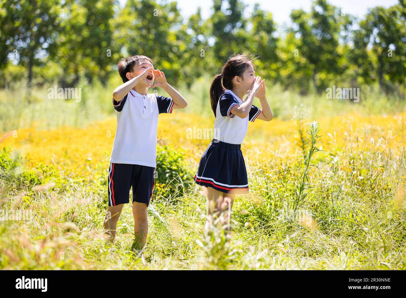 Cheerful Chinese school children relaxing in park Stock Photo - Alamy
