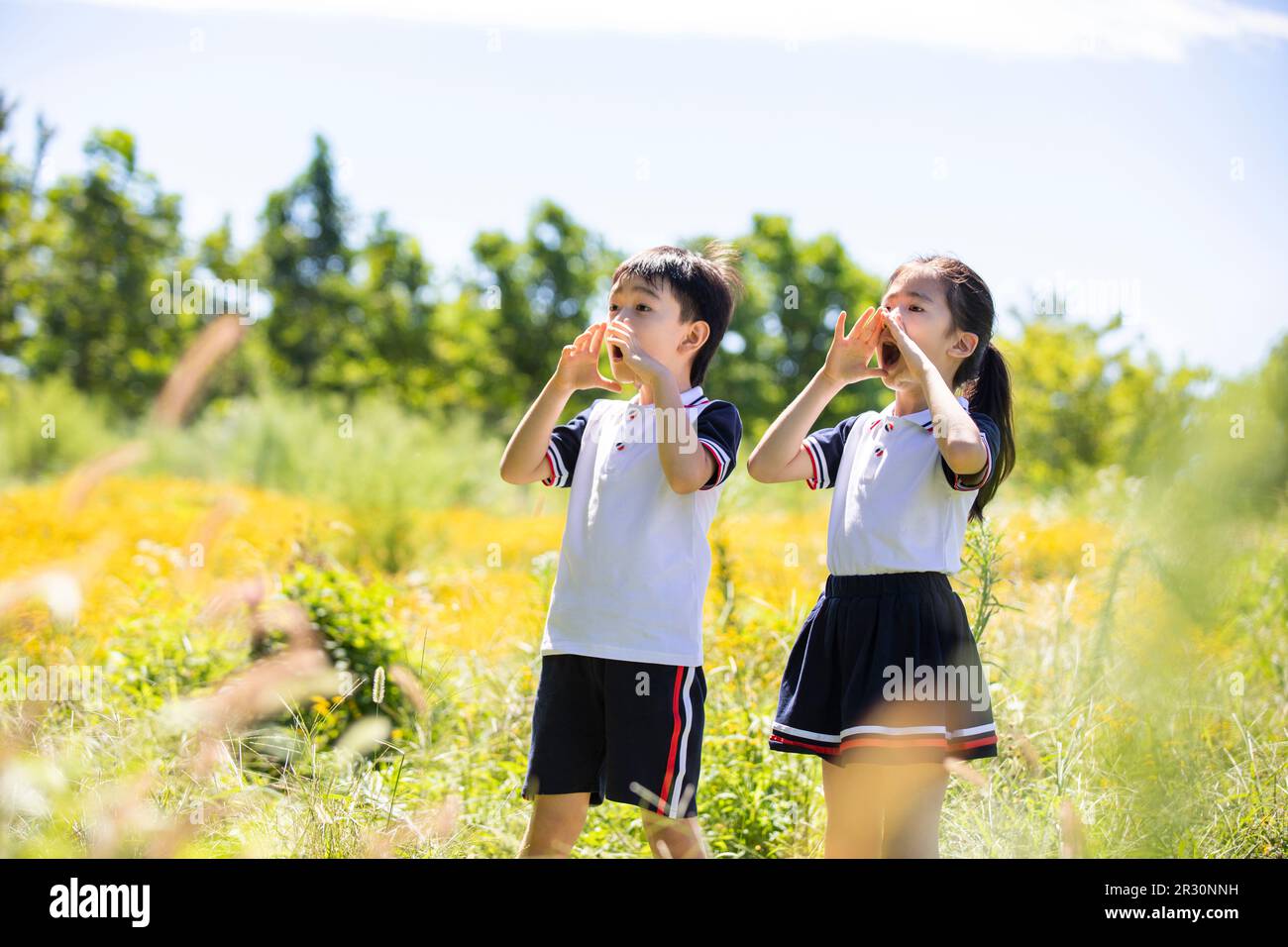 Cheerful Chinese school children relaxing in park Stock Photo - Alamy