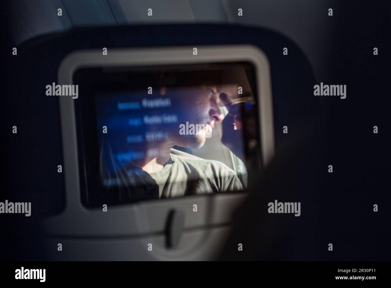Reflection of a passenger on an airplane touch screen monitor during ...