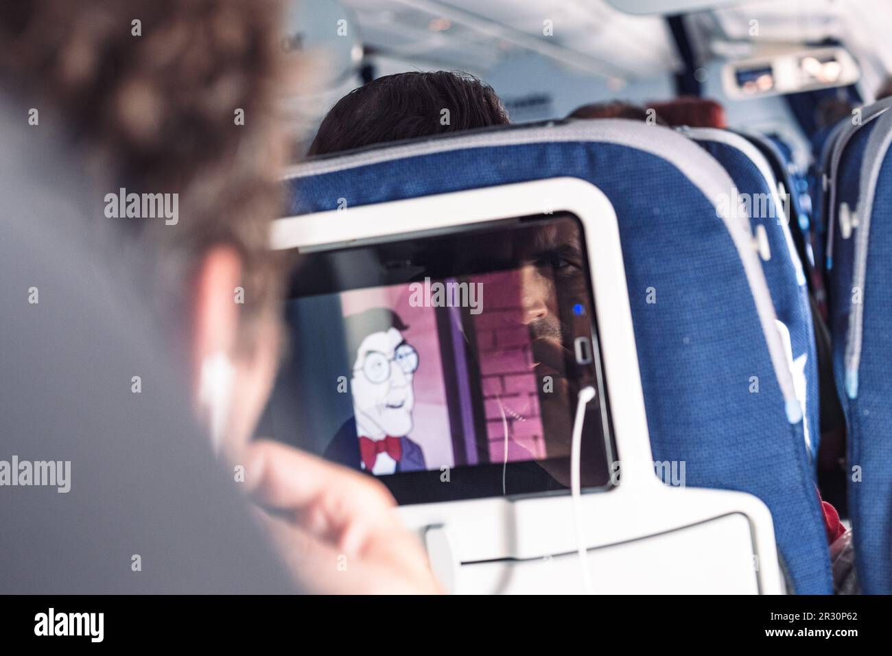 Reflection of a passenger on an airplane touch screen monitor while ...