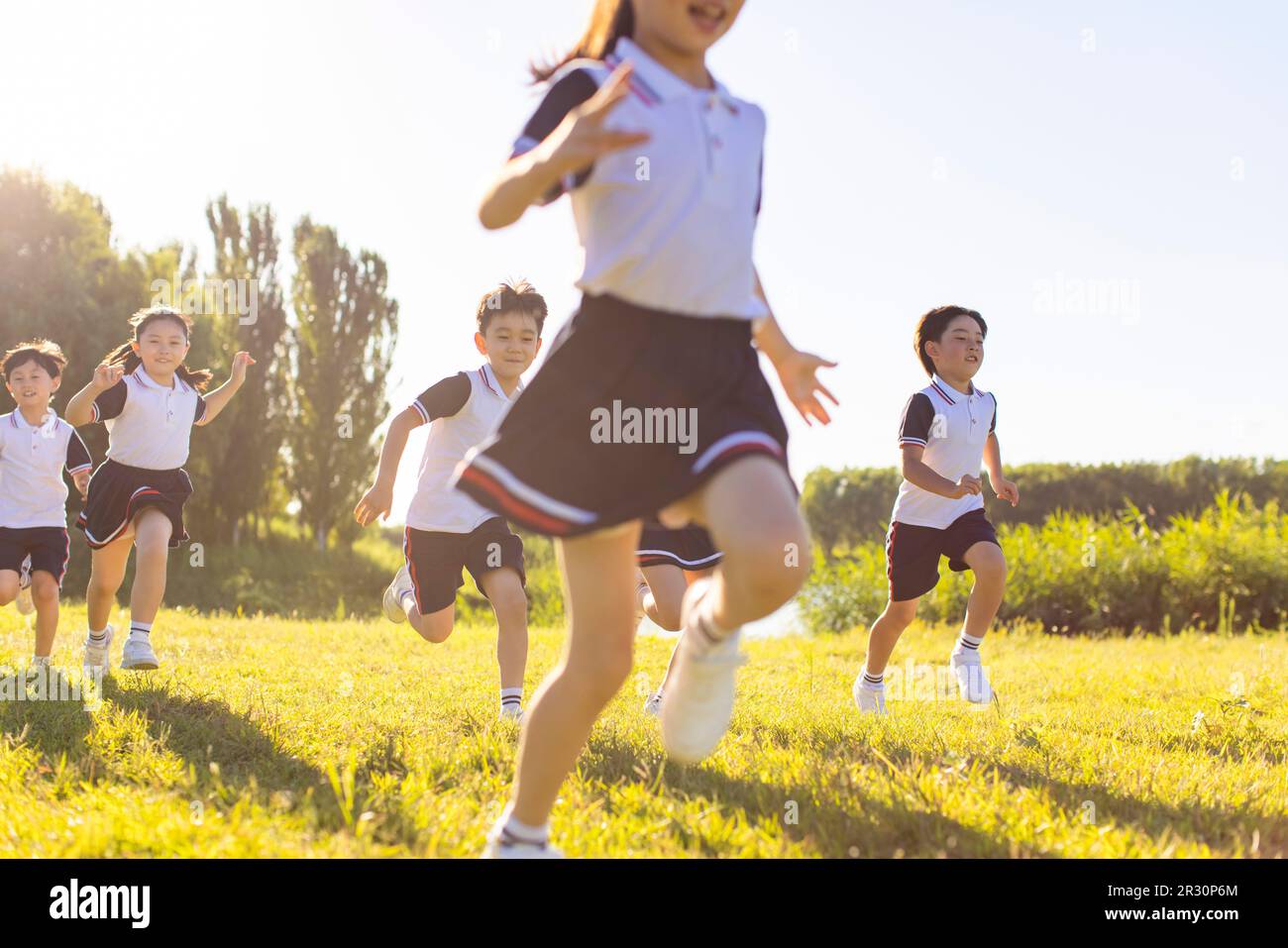 Cheerful Chinese school children relaxing in park Stock Photo - Alamy