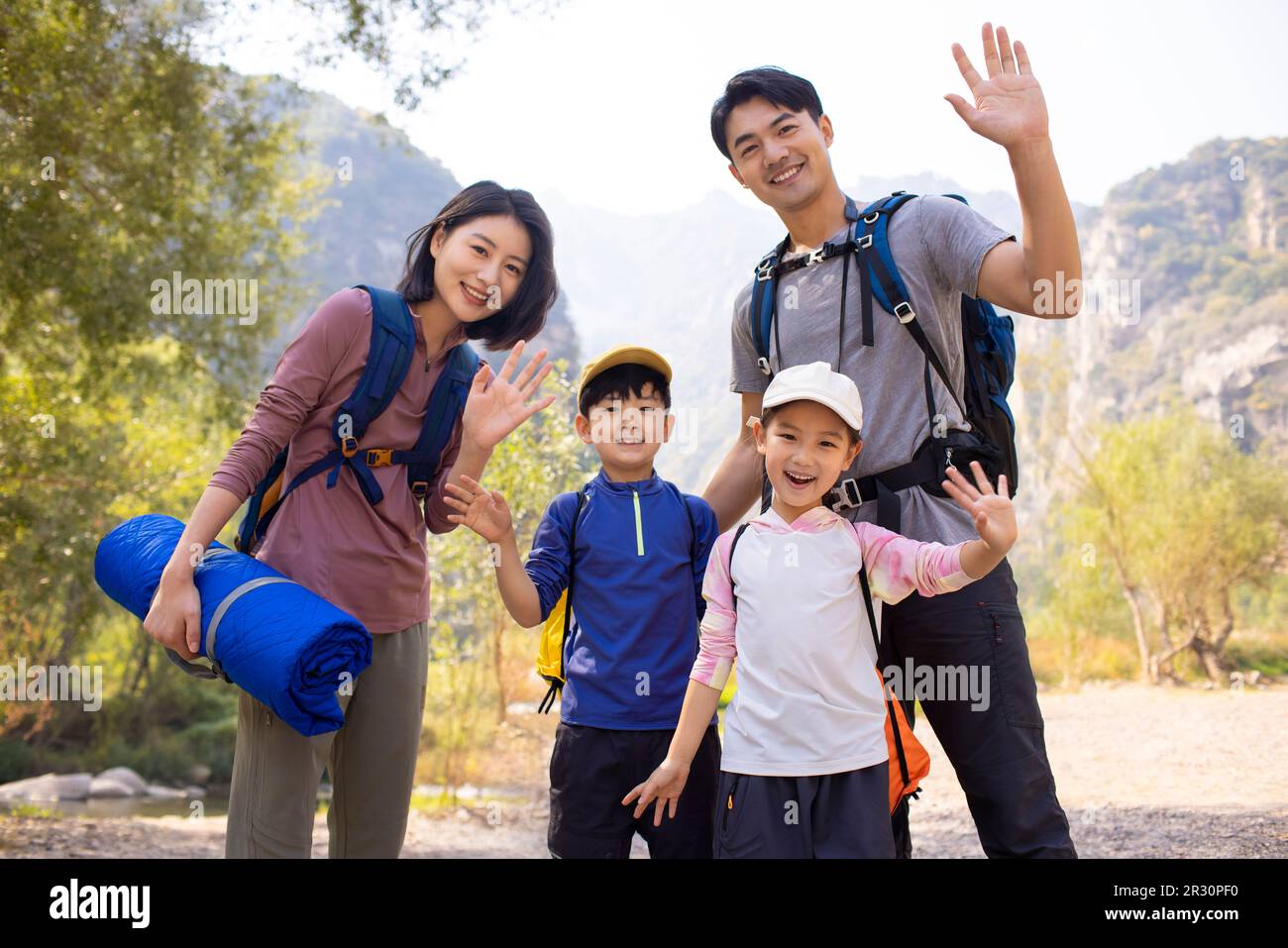Happy young Chinese family hiking outdoors Stock Photo - Alamy