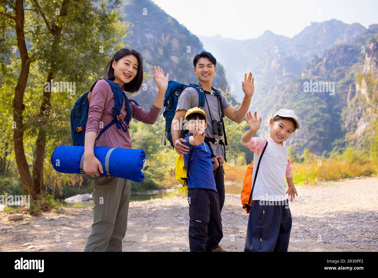 Happy young Chinese family hiking outdoors Stock Photo - Alamy