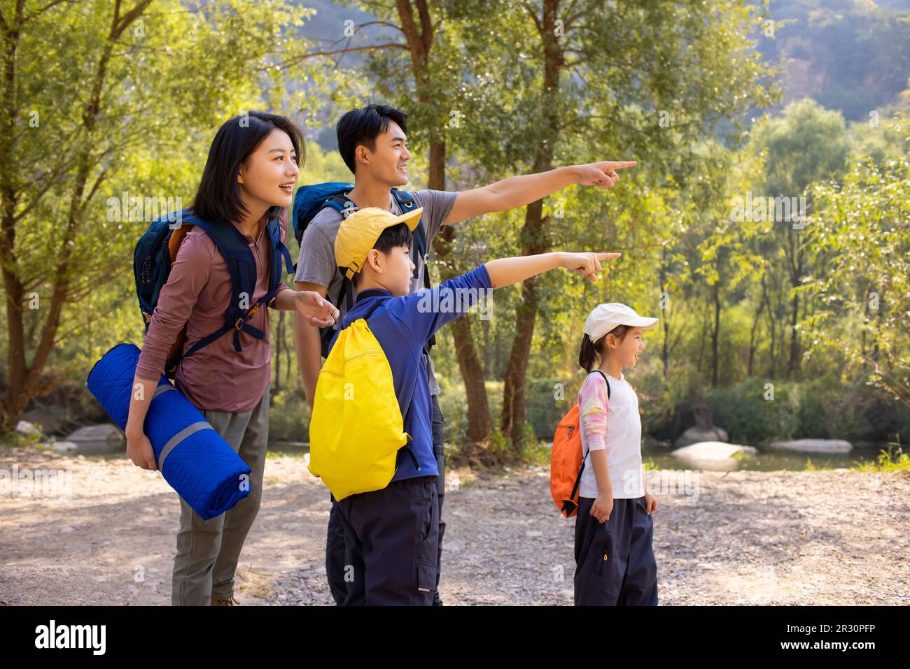 Happy young Chinese family hiking outdoors Stock Photo - Alamy