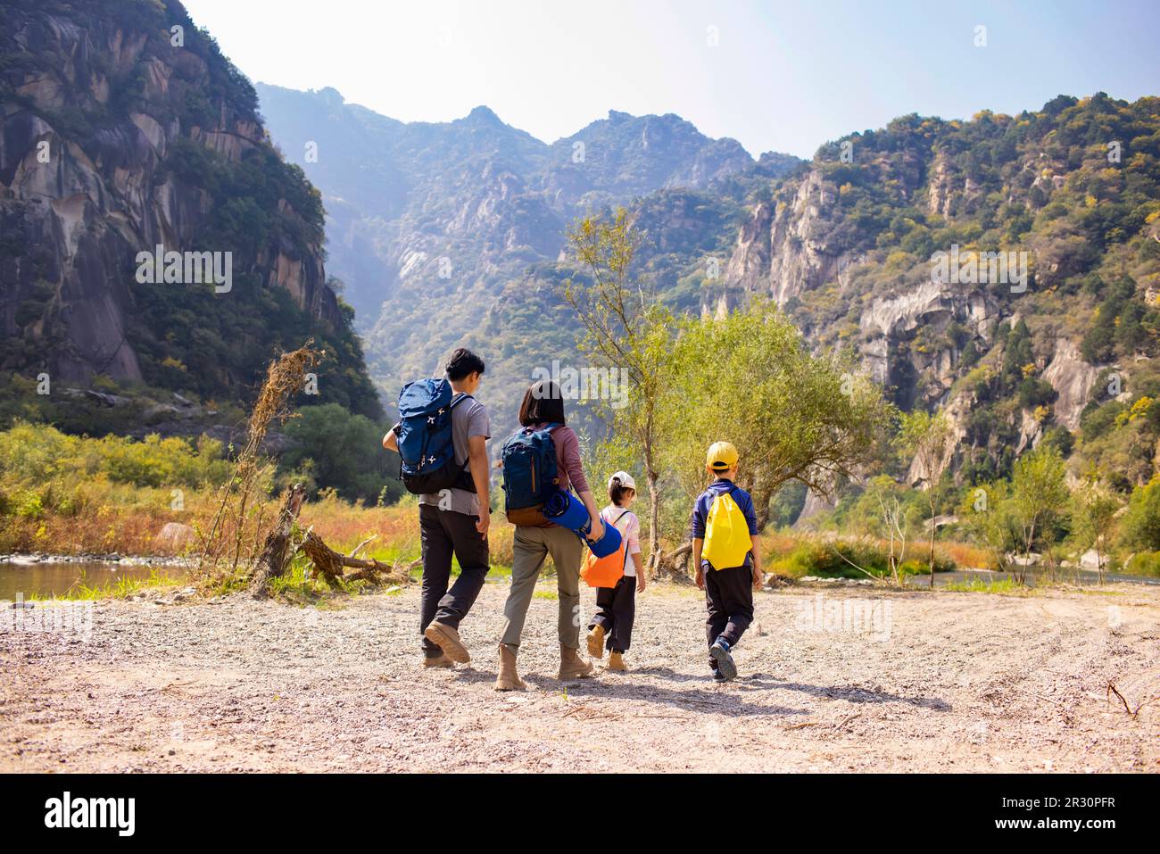 Happy young Chinese family hiking outdoors Stock Photo - Alamy