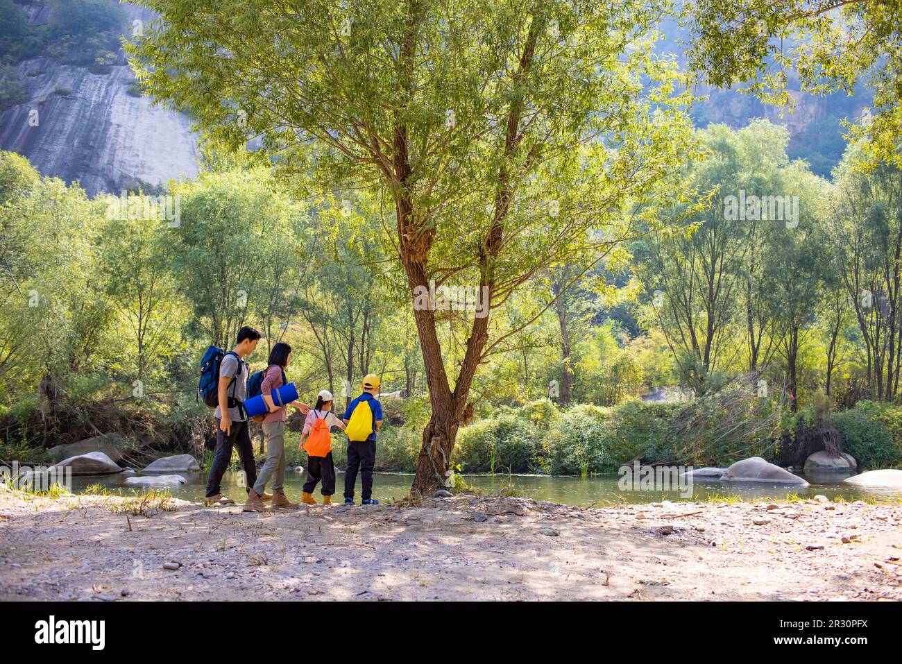 Happy young Chinese family hiking outdoors Stock Photo - Alamy
