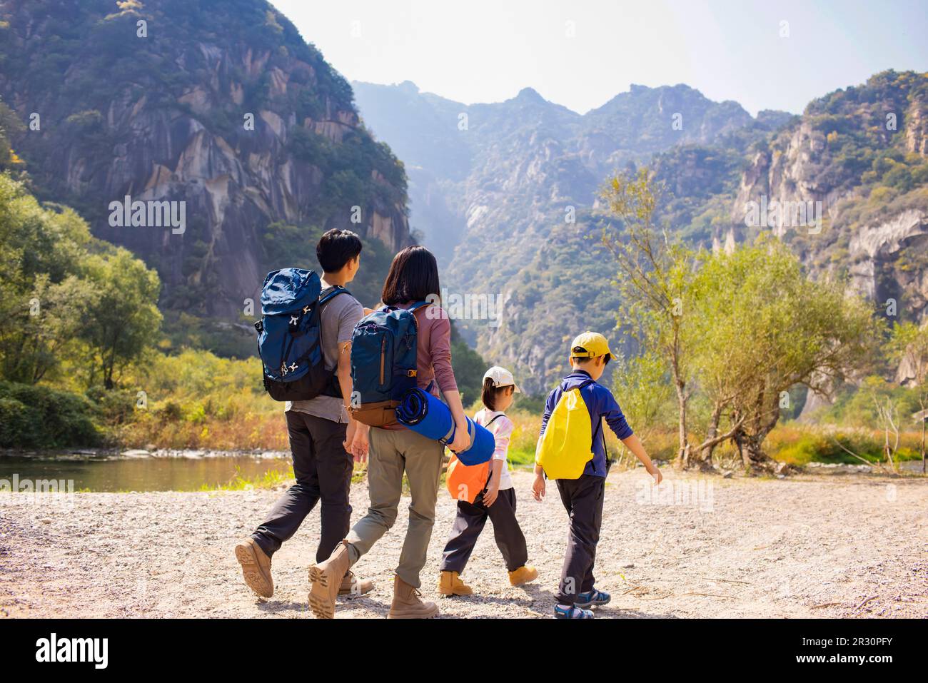 Happy young Chinese family hiking outdoors Stock Photo - Alamy