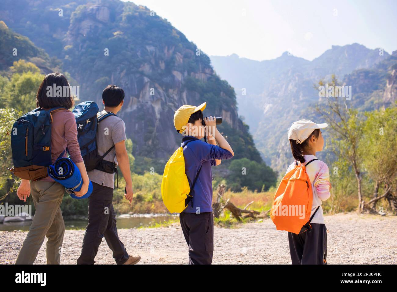 Happy young Chinese family hiking outdoors Stock Photo - Alamy
