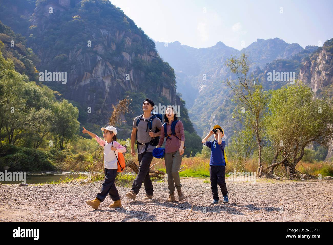 Happy young Chinese family hiking outdoors Stock Photo - Alamy