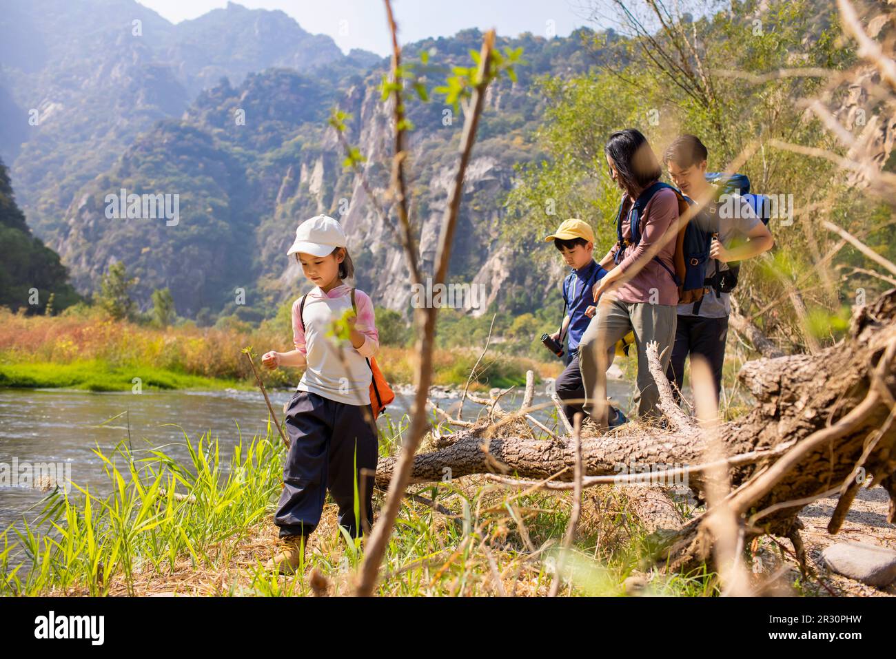 Happy young Chinese family hiking outdoors Stock Photo - Alamy