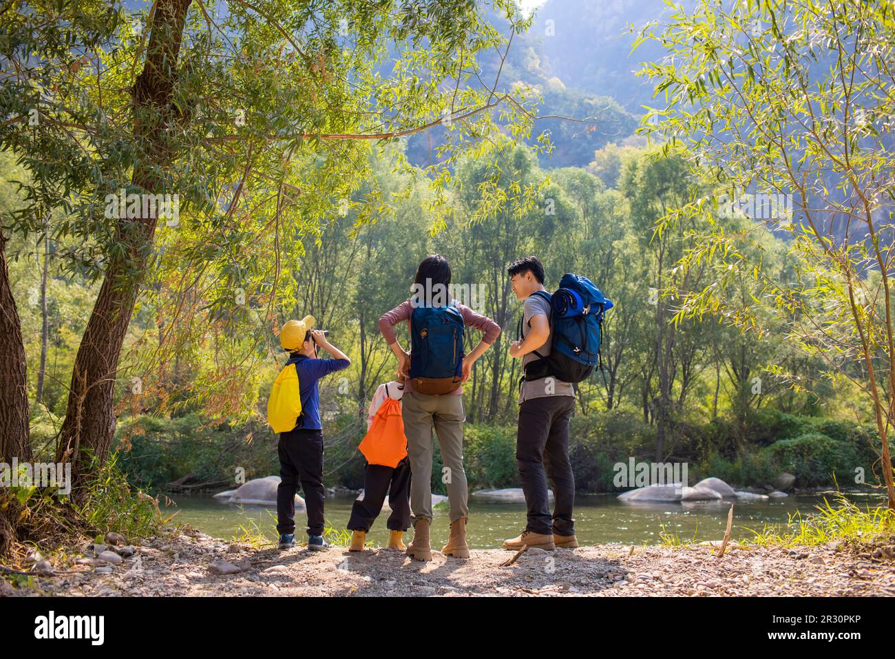 Happy young Chinese family hiking outdoors Stock Photo - Alamy