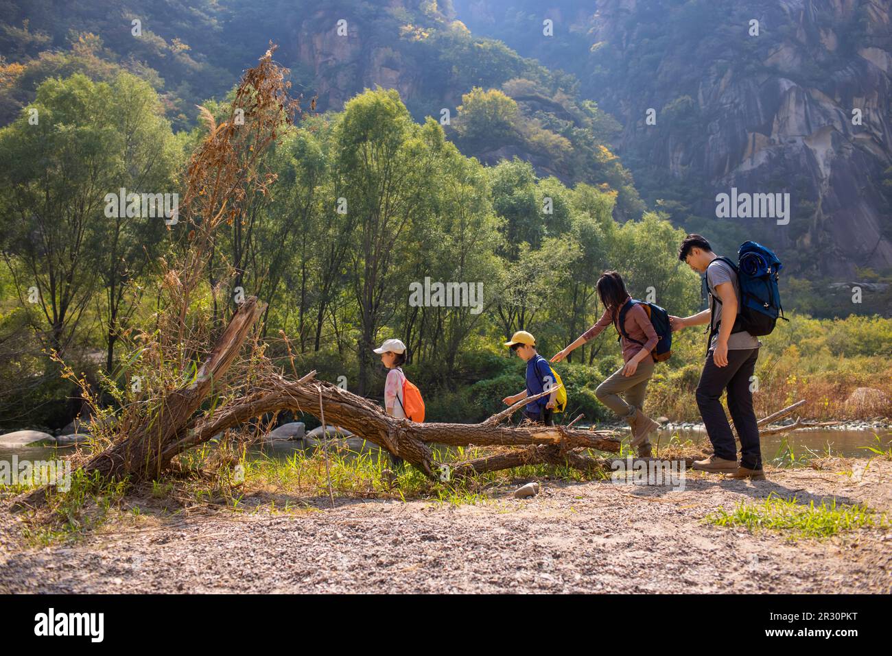 Happy young Chinese family hiking outdoors Stock Photo - Alamy
