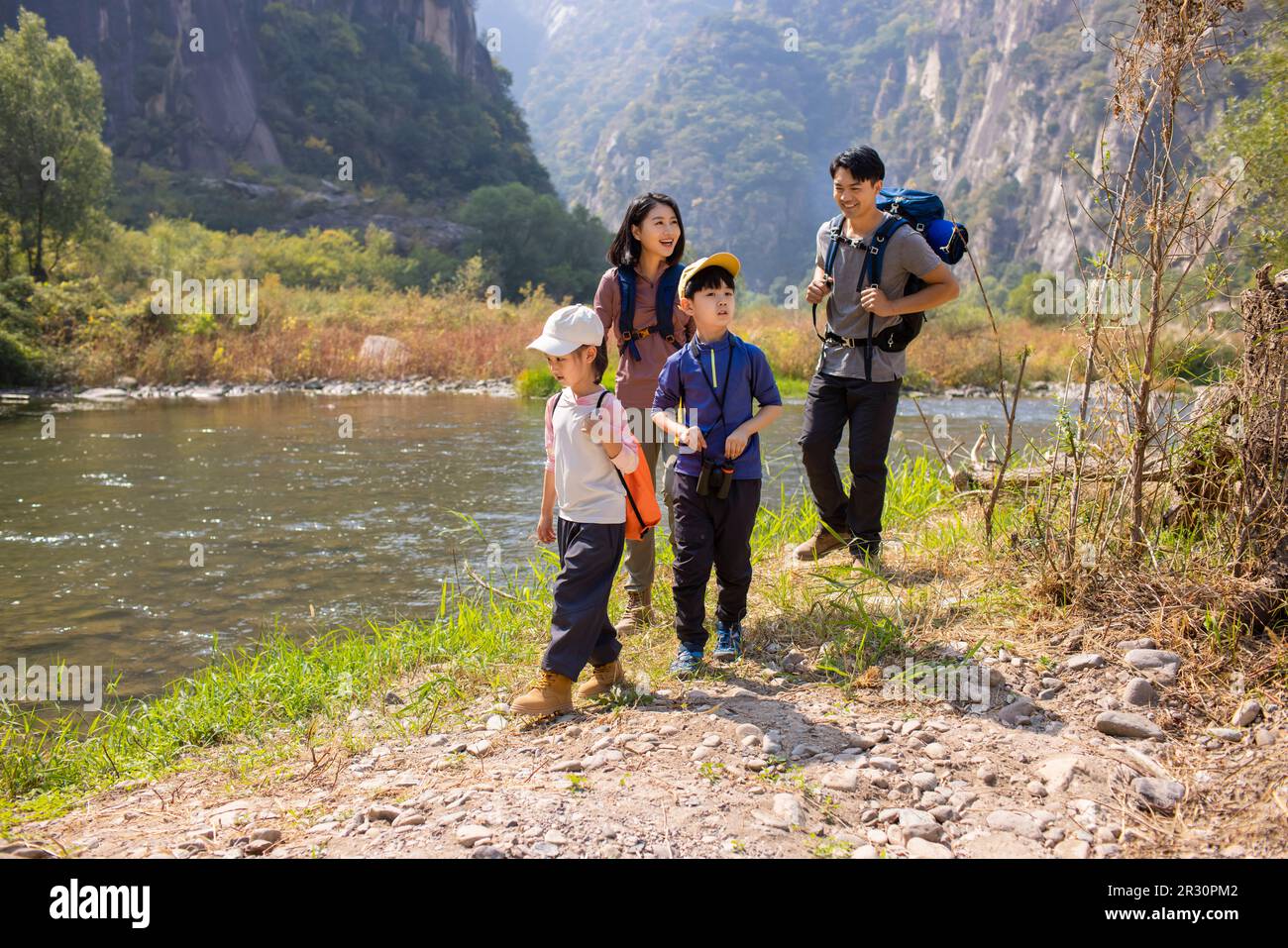 Happy young Chinese family hiking outdoors Stock Photo - Alamy