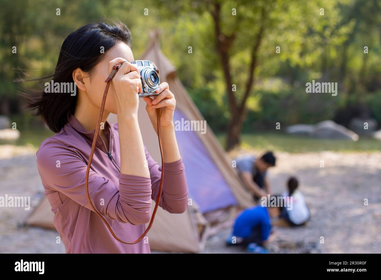 Happy young Chinese family camping outdoors Stock Photo - Alamy