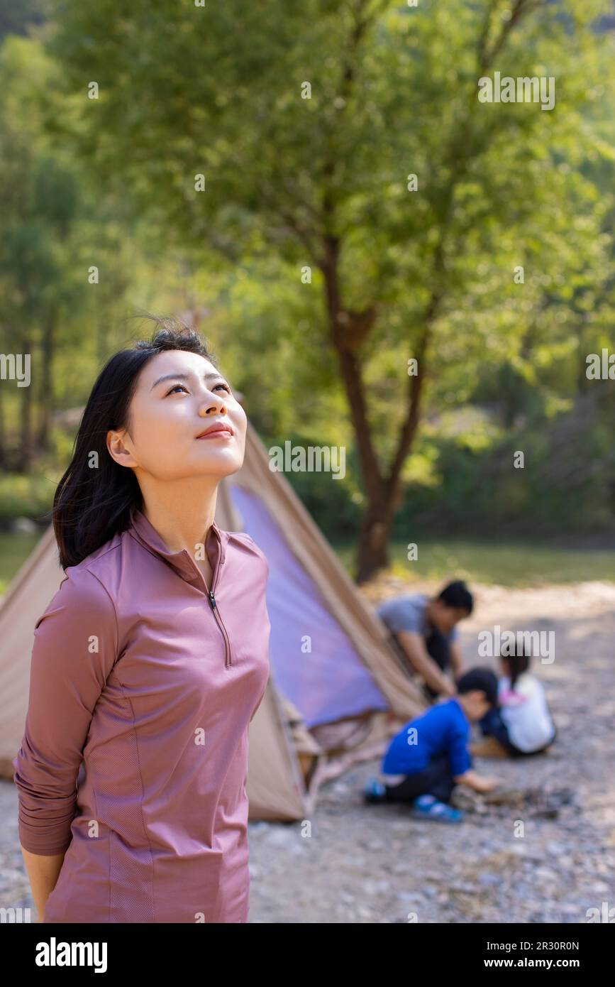 Happy young Chinese family camping outdoors Stock Photo - Alamy
