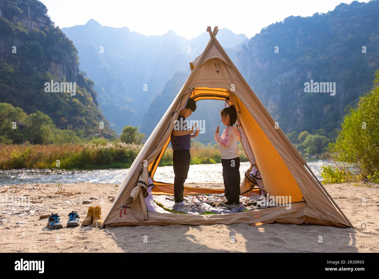 Cute Chinese Children relaxing in tent Stock Photo - Alamy