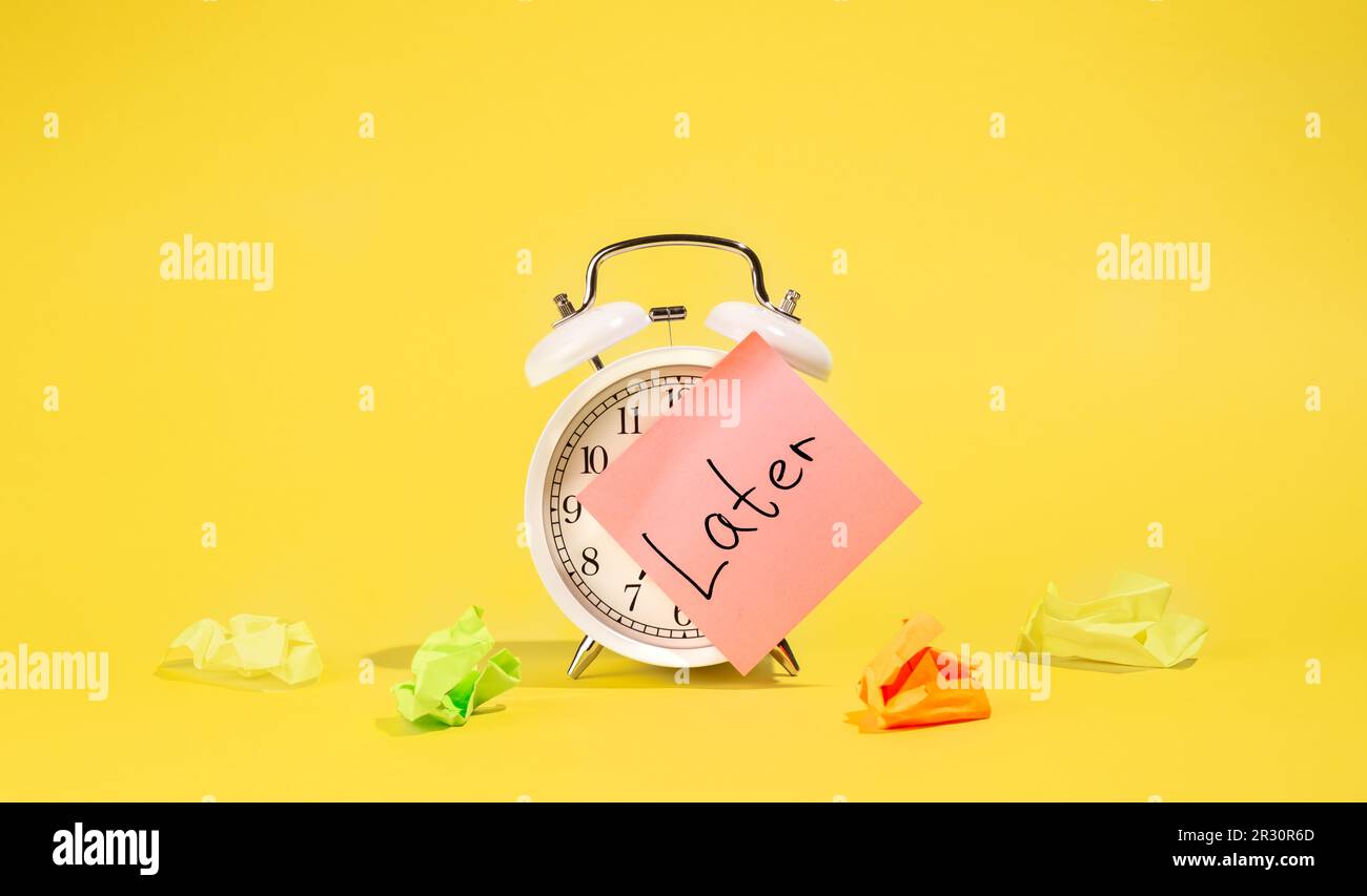 Alarm clock and paper reminder with inscription Later, isolated Stock ...