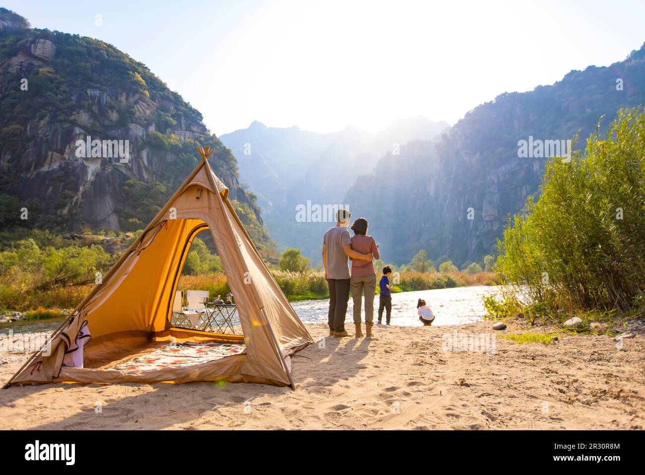 Happy young Chinese family camping outdoors Stock Photo - Alamy