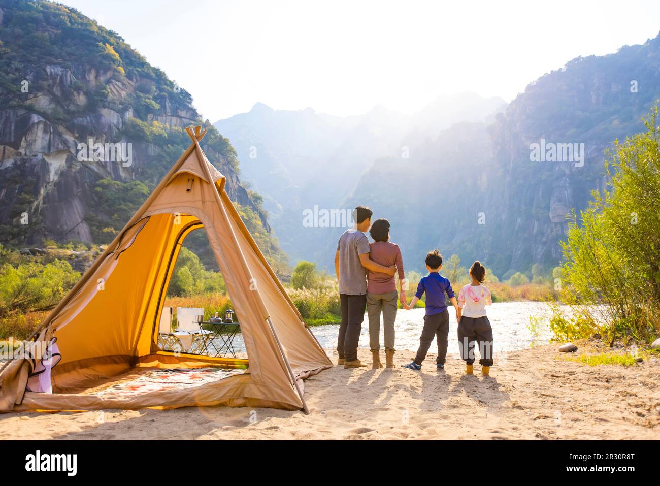 Happy young Chinese family camping outdoors Stock Photo - Alamy