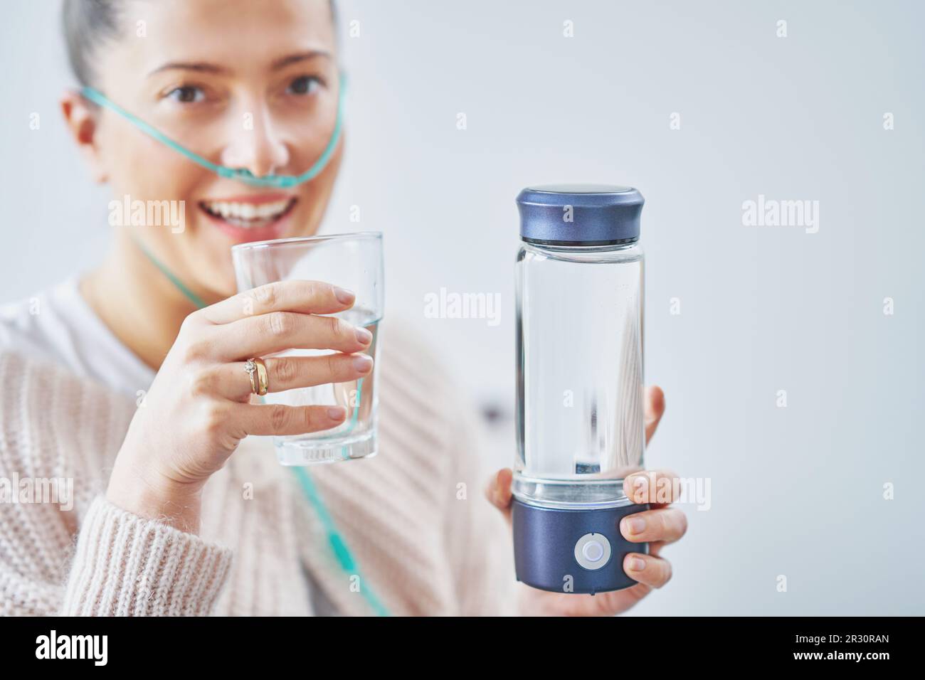 Picture of woman having hydrogen water in hand Stock Photo - Alamy