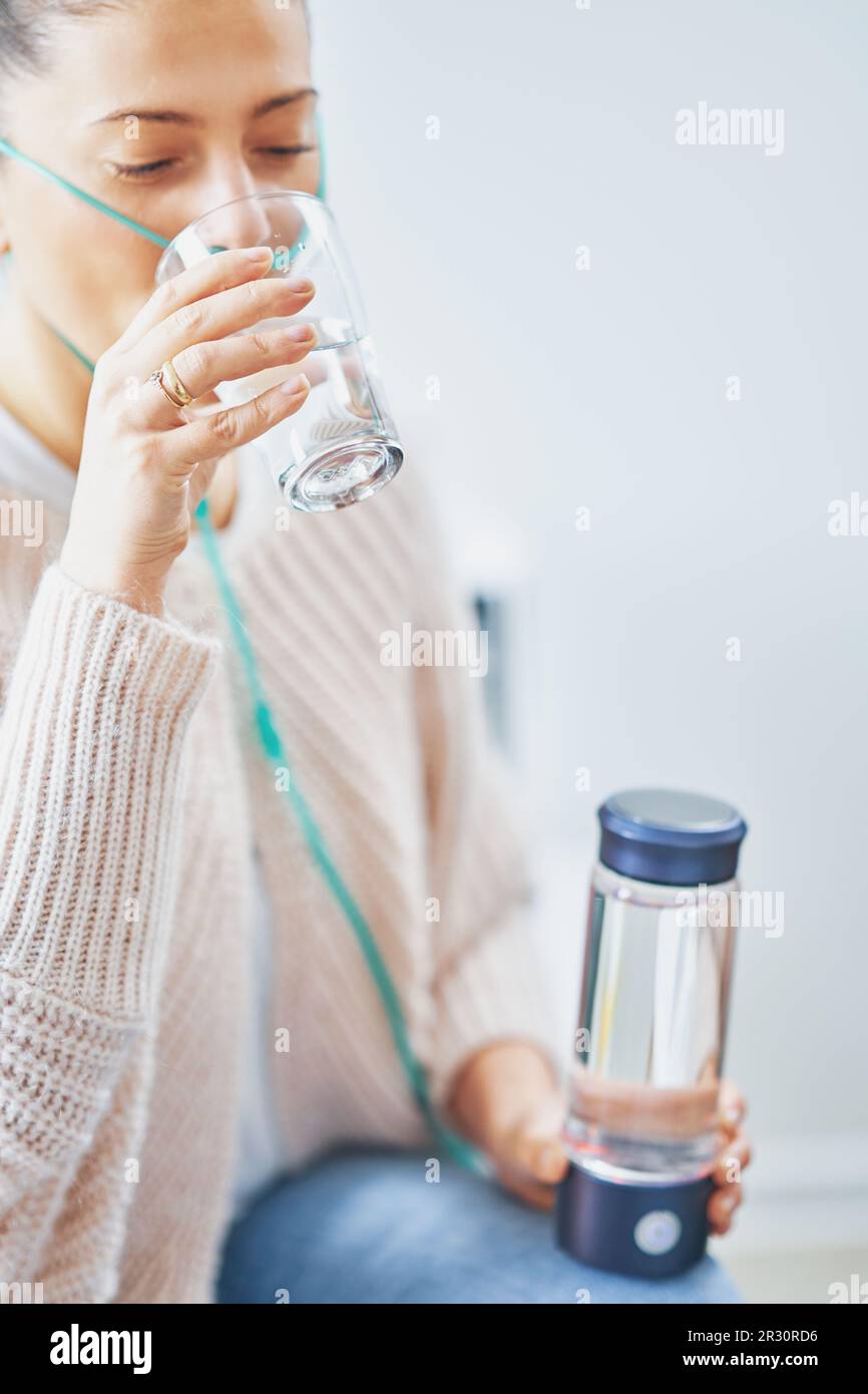 Picture of woman having hydrogen water in hand Stock Photo - Alamy