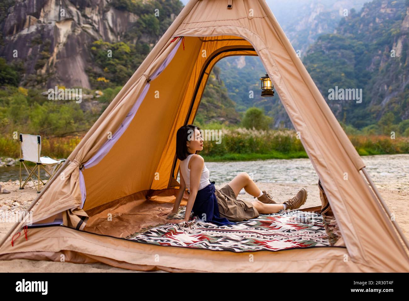Young Chinese woman camping outdoors Stock Photo - Alamy