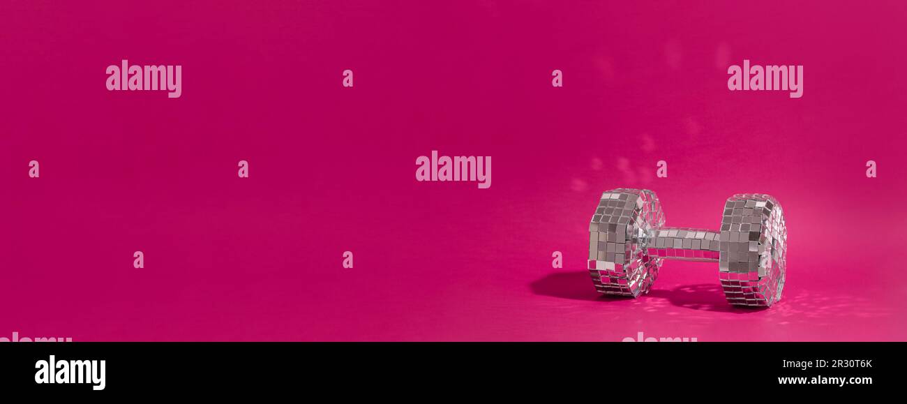 Dumbbell on magenta background. Shining bright sport. Banner with copy ...