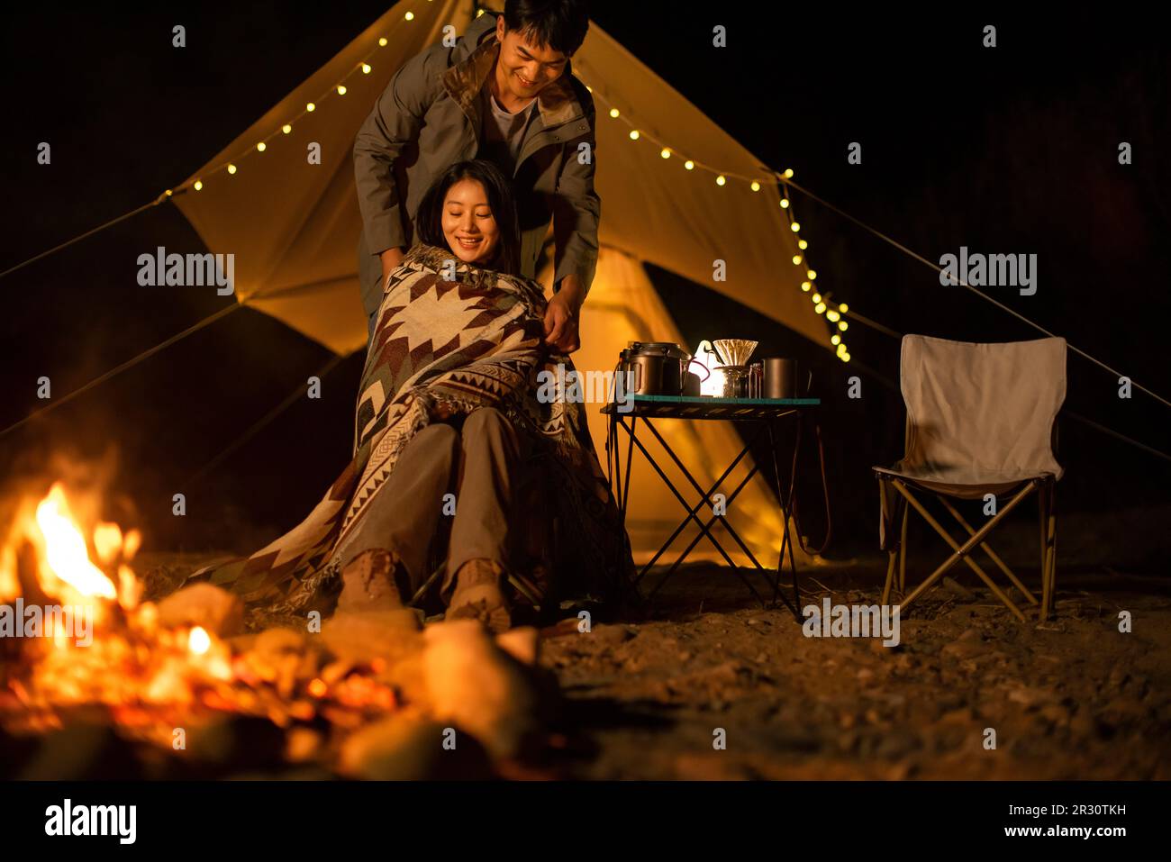 Happy young Chinese couple camping outdoors Stock Photo - Alamy