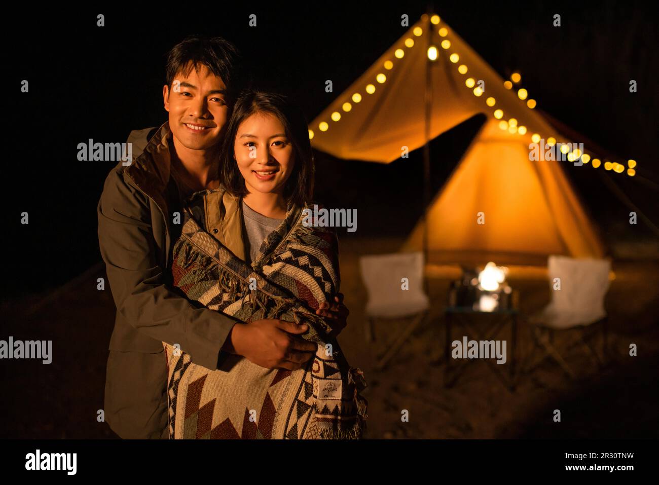 Happy young Chinese couple camping outdoors Stock Photo - Alamy