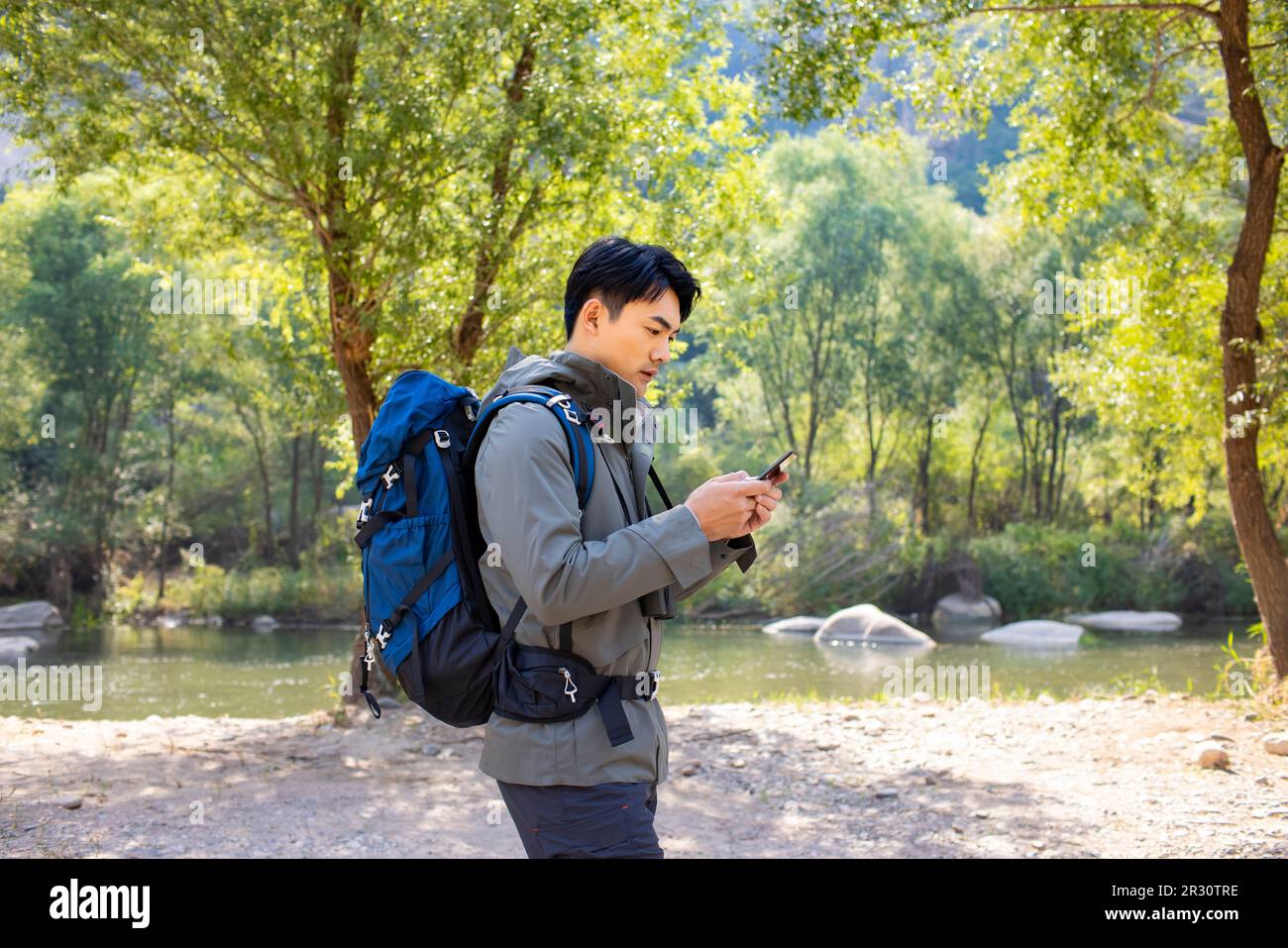 Young Chinese man hiking outdoors Stock Photo - Alamy