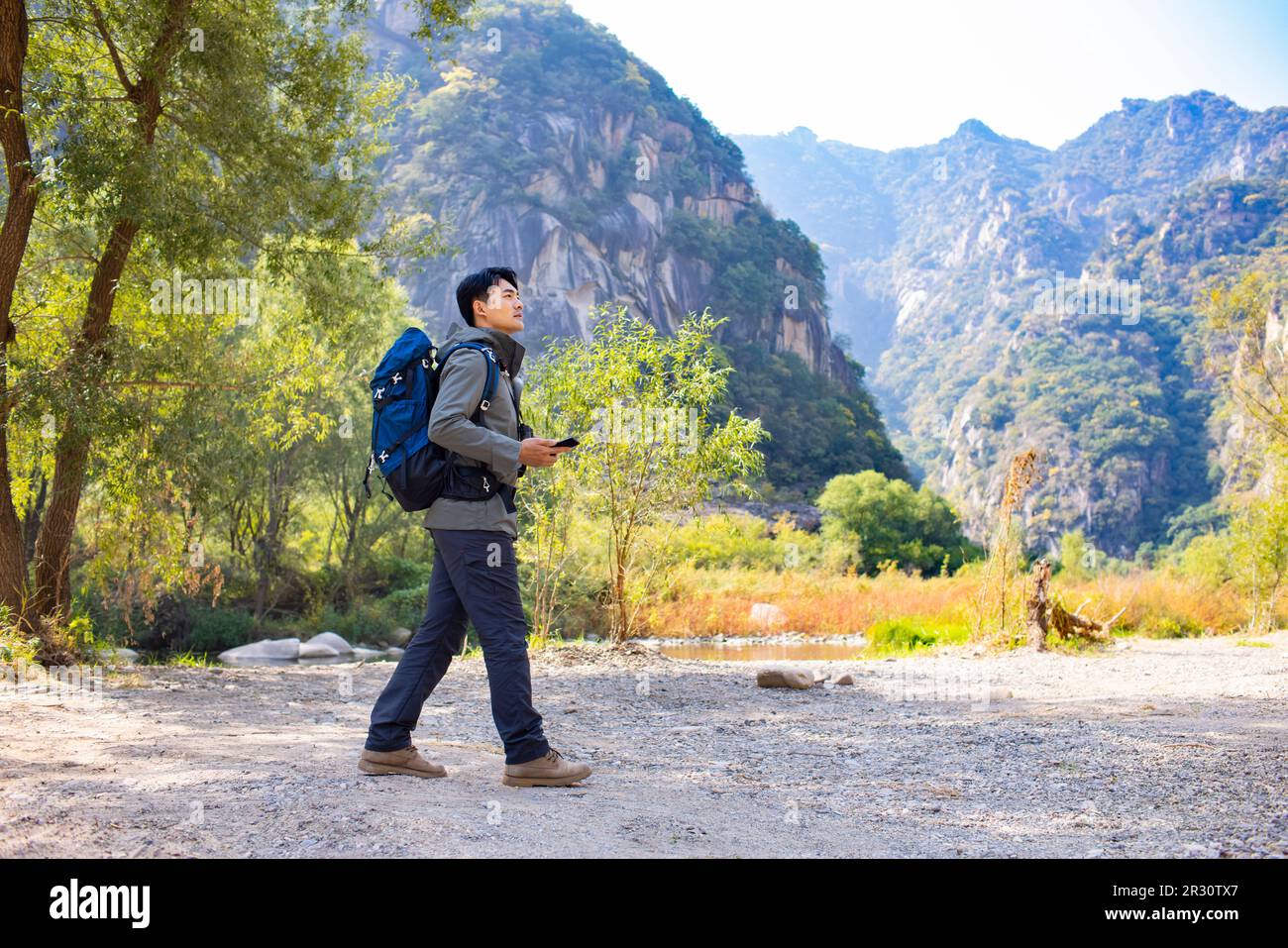 Young Chinese man hiking outdoors Stock Photo - Alamy